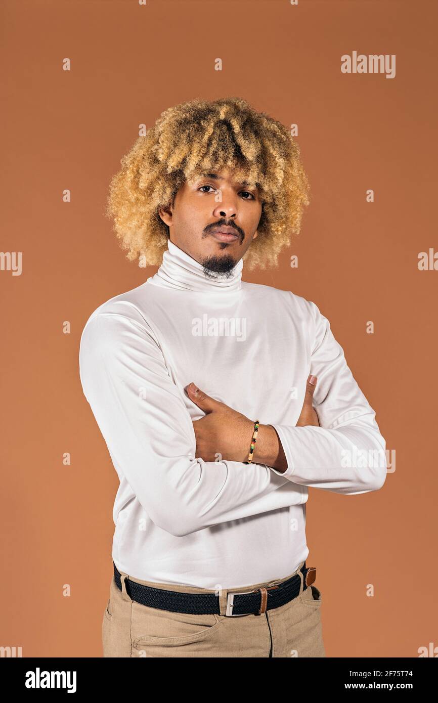 Stock photo of cool afro man smiling and looking at camera in studio ...