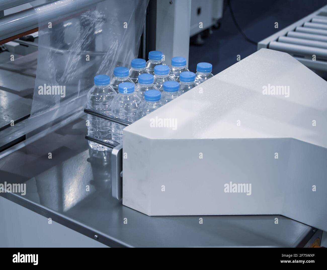 Automatic shrink film wrapping machine for bottle of water Stock Photo ...