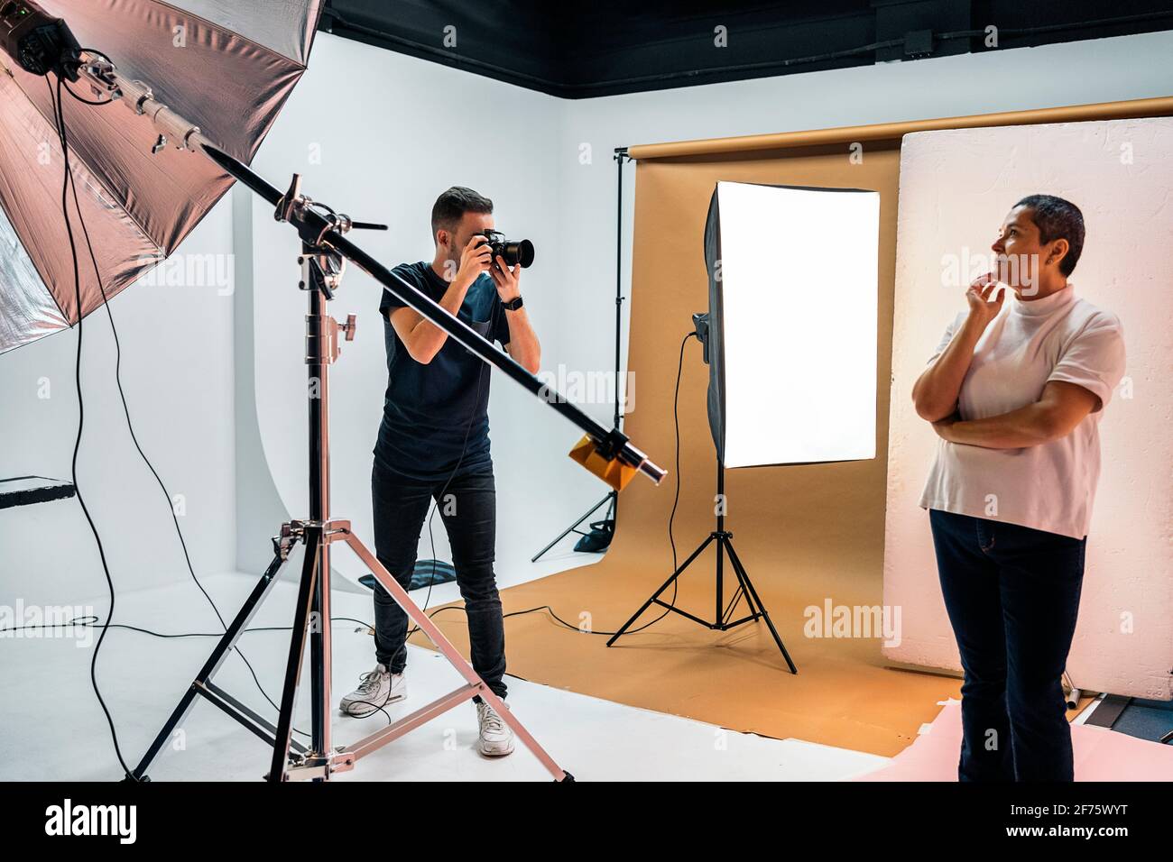 Stock photo of professional photographer during photo shoot in studio ...