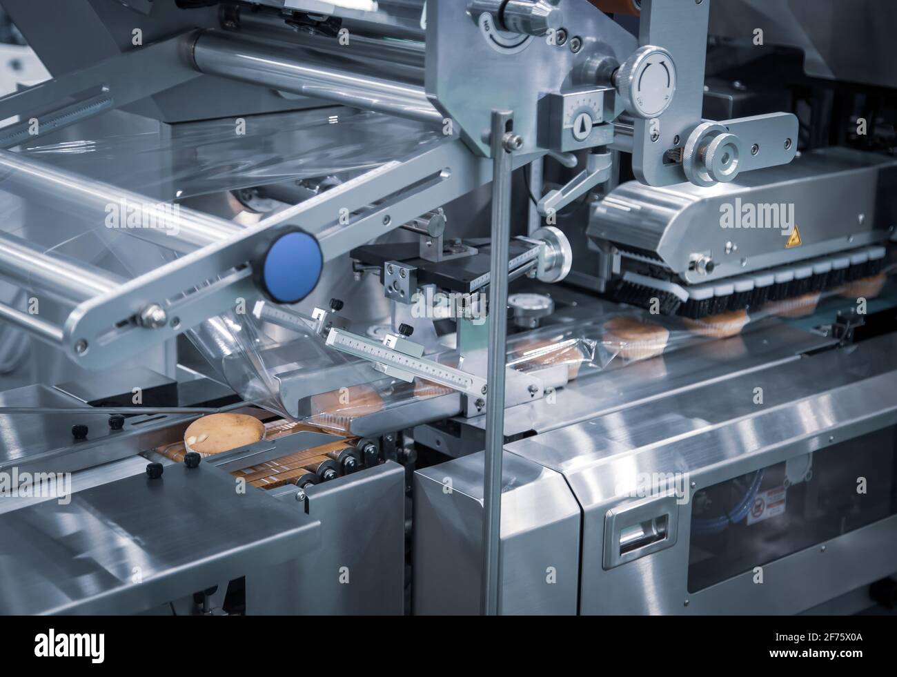 Automatic packing of bakery product flow pillow packing machine. Bread, toast, bun plastic ...