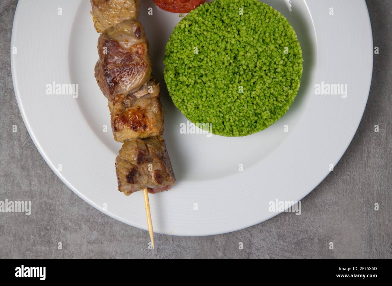 Lamb brochette marinated in spices, green semolina Stock Photo - Alamy