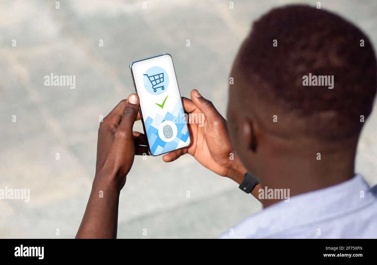 African American man holding smartphone, shopping online Stock Photo ...