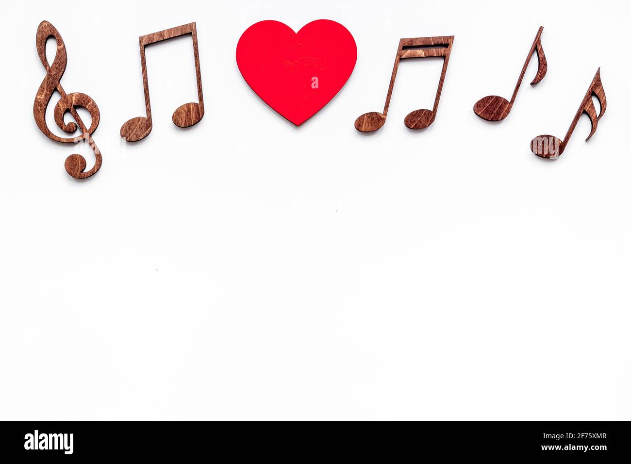 Love songs - musical wooden notes with heart, top view Stock Photo - Alamy