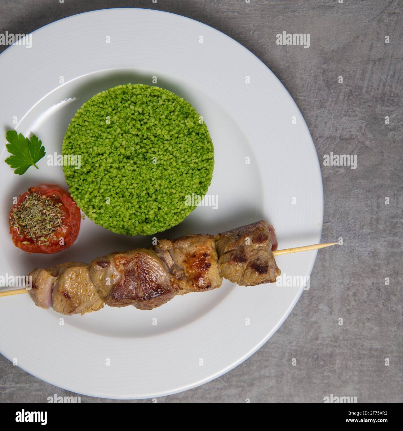 Lamb brochette marinated in spices, green semolina Stock Photo - Alamy