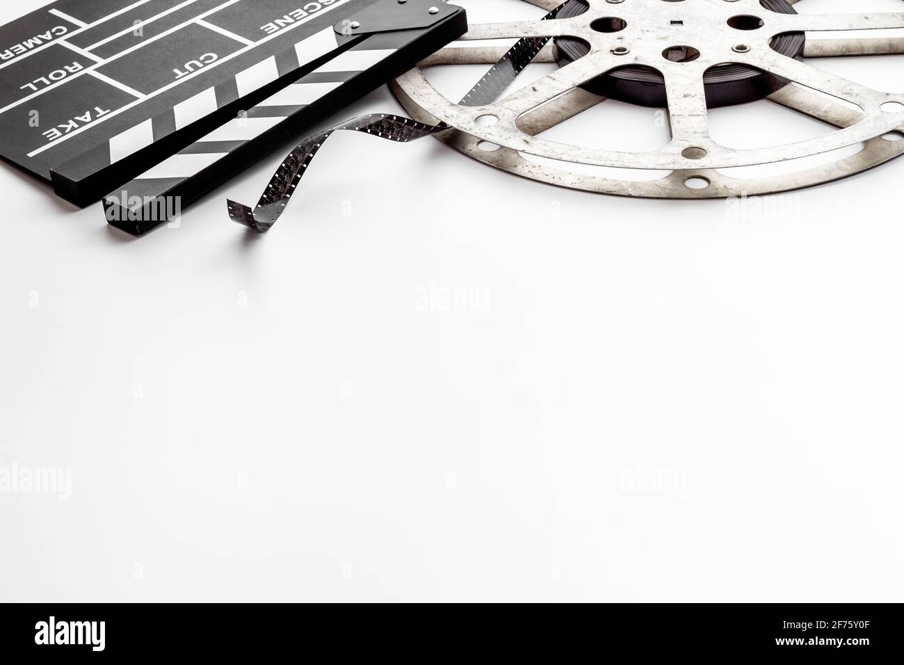 Movie clapper with film reel. Cinema background Stock Photo - Alamy