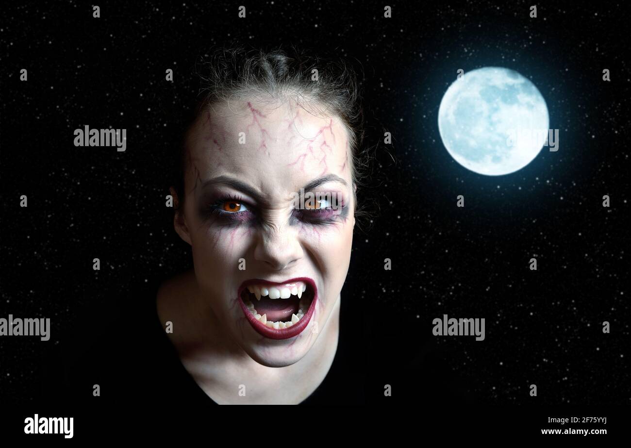 Halloween angry vampire woman in night sky with moon. Horror theme ...