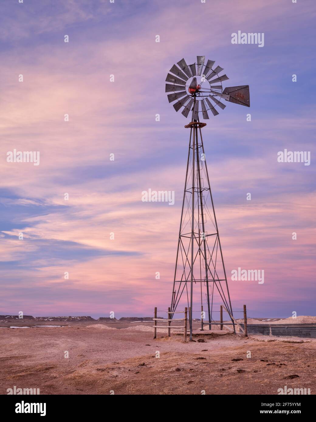 windmill with a pump and cattle water tank in shortgrass prairie ...