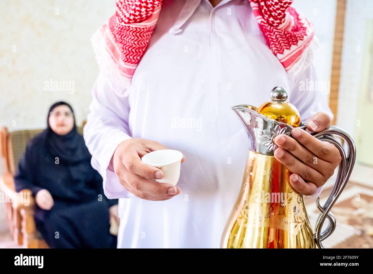 Arabic man serving coffee Stock Photo - Alamy