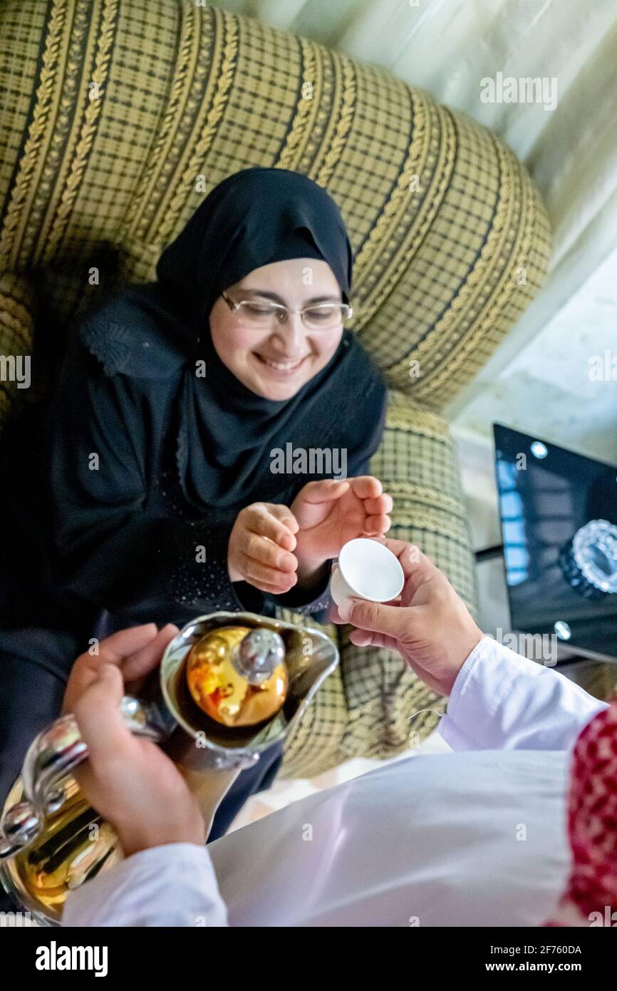 Arabic man serving coffee Stock Photo - Alamy