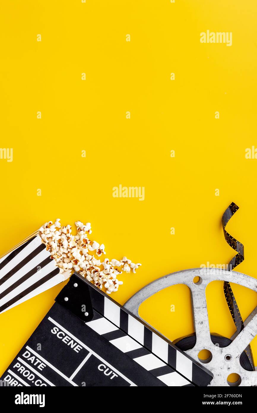 Layout of film reel with popcorn and clapperboard. Cinema concept Stock ...