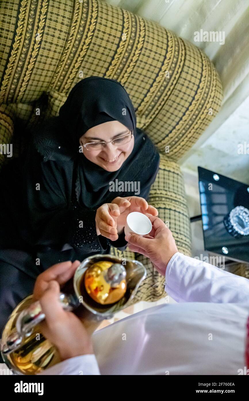 Arabic man serving coffee Stock Photo - Alamy