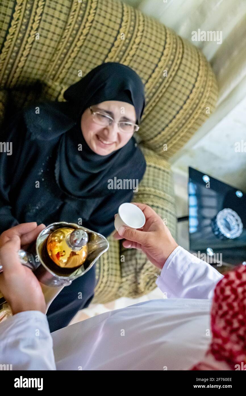 Arabic man serving coffee Stock Photo - Alamy