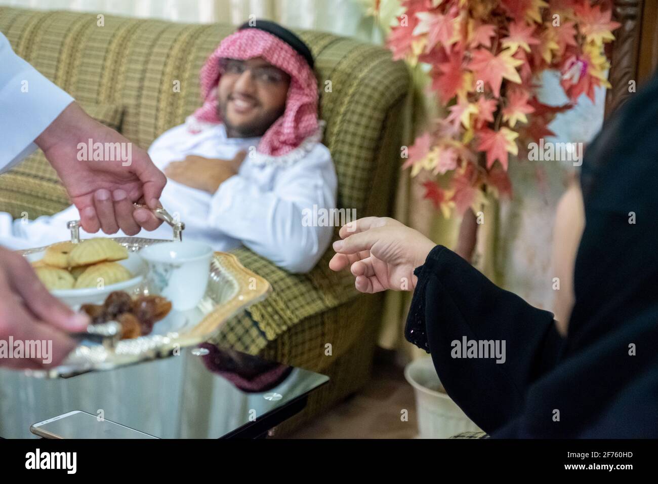 Arabic man serving coffee Stock Photo - Alamy