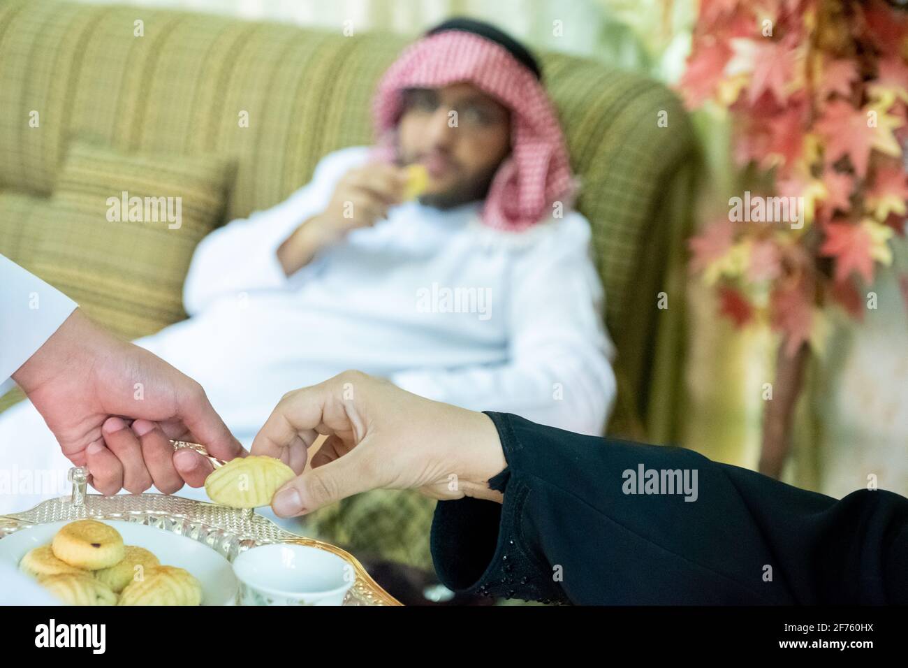 Arabic man serving coffee Stock Photo - Alamy