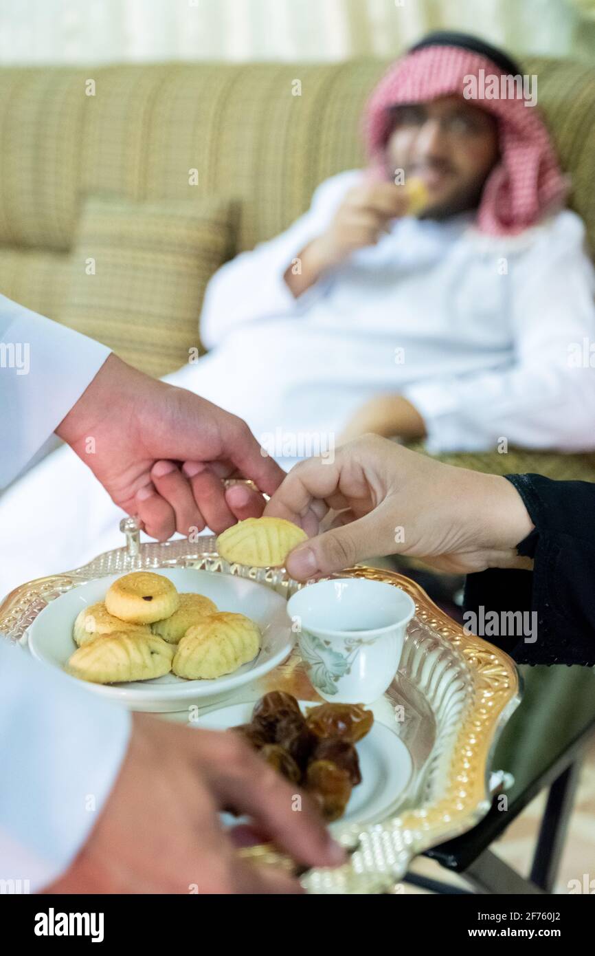 Arabic man serving coffee Stock Photo - Alamy