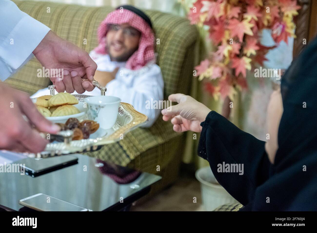 Arabic man serving coffee Stock Photo - Alamy