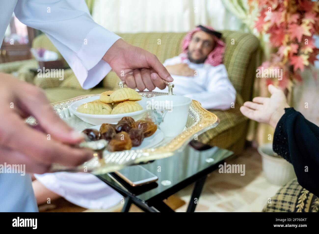 Arabic man serving coffee Stock Photo - Alamy