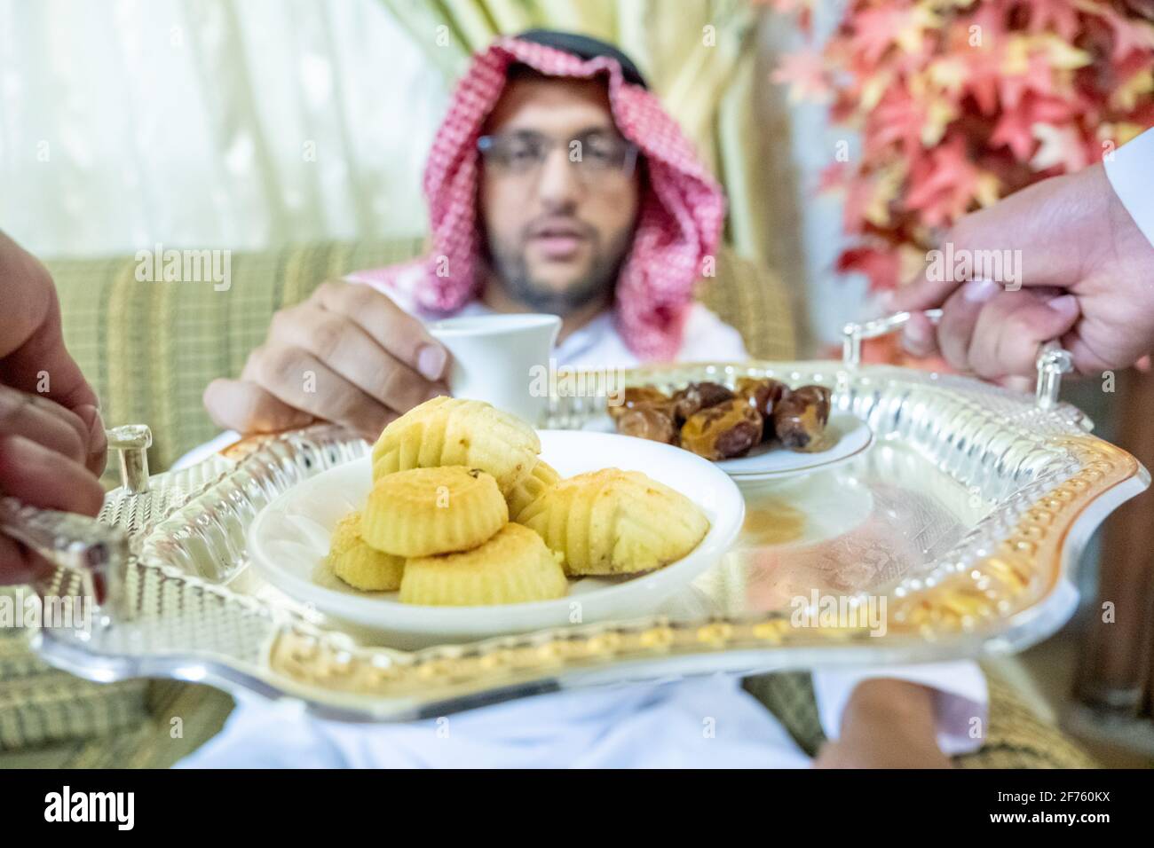 Arabic man serving coffee Stock Photo - Alamy