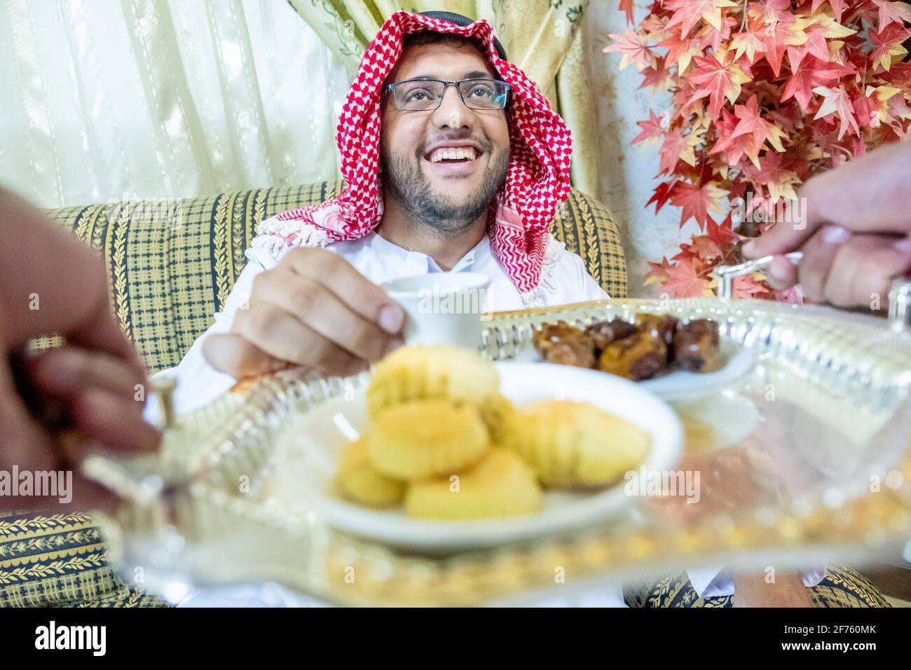 Arabic man serving coffee Stock Photo - Alamy