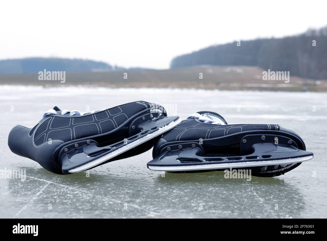 Black hockey skates on a ice rink Stock Photo - Alamy