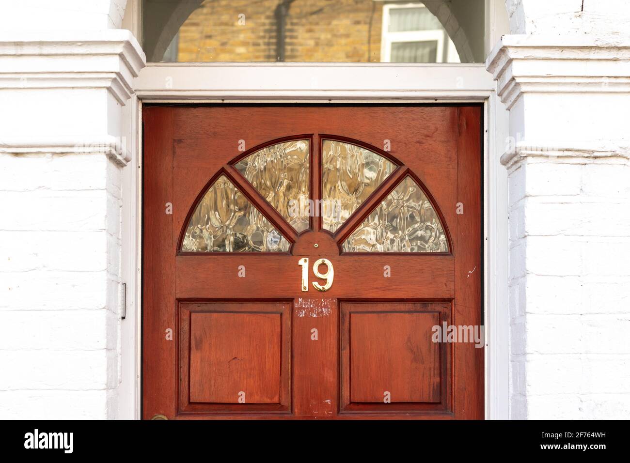House number 19 on a recessed brown front door Stock Photo - Alamy