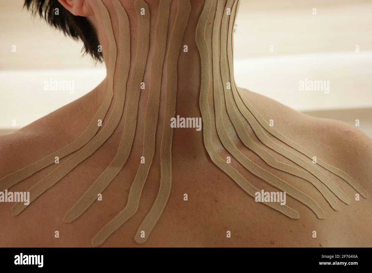 Kinesio tapes on female neck and chest Stock Photo - Alamy