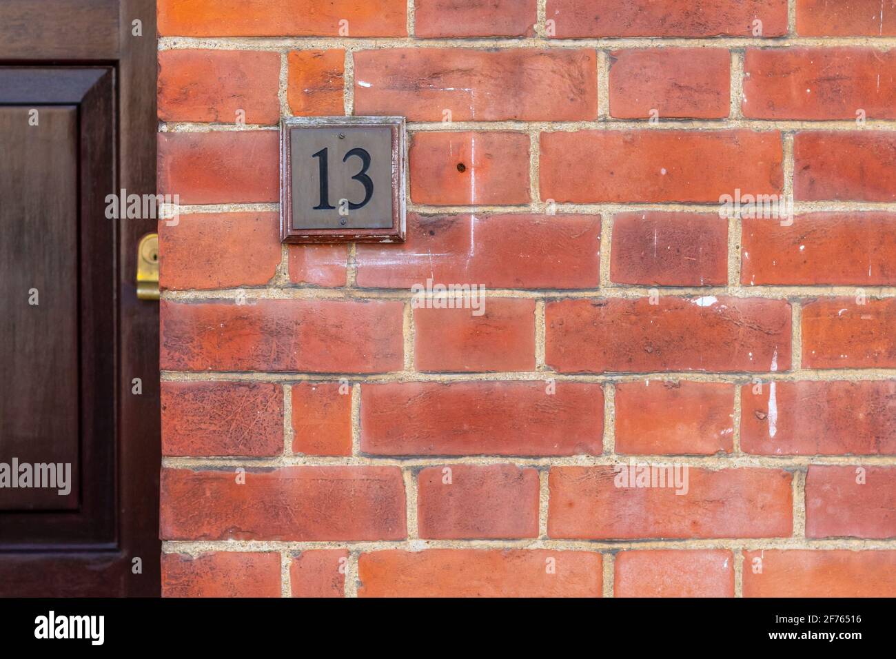 House number 13 on a red brick wall Stock Photo - Alamy