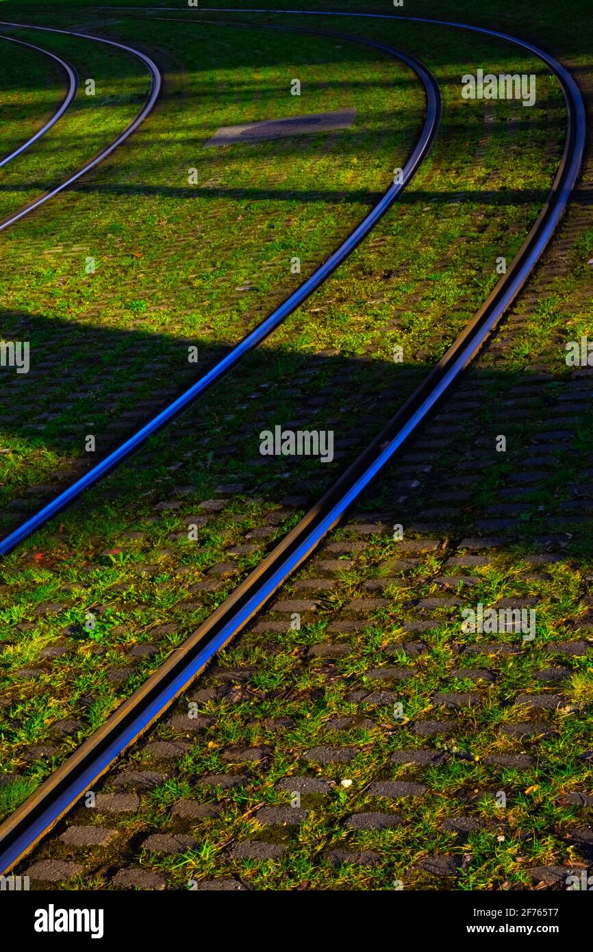 railroad tracks in the grass, disappearing behind the road turn Stock ...