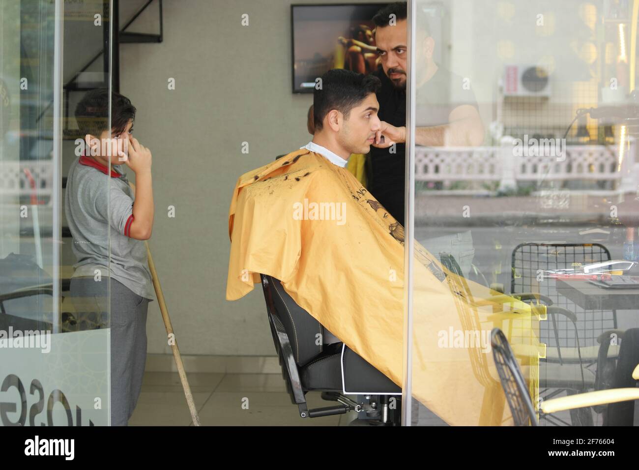 Barber trimming clients hair hi-res stock photography and images - Alamy