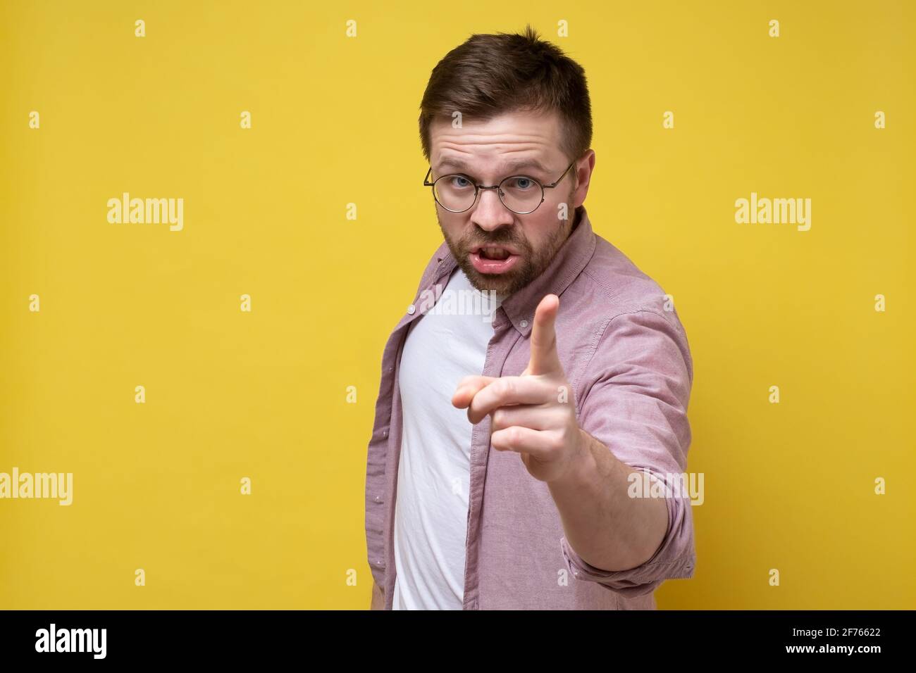 Angry, aggressive Caucasian man with glasses points index finger at ...