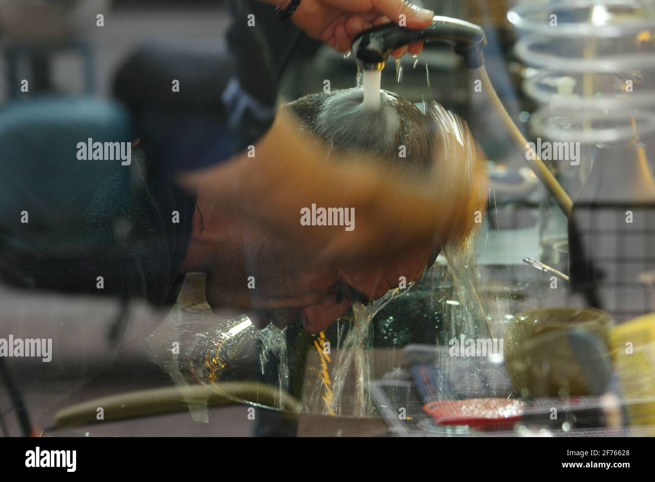 Washing her face in a sink hi-res stock photography and images - Alamy