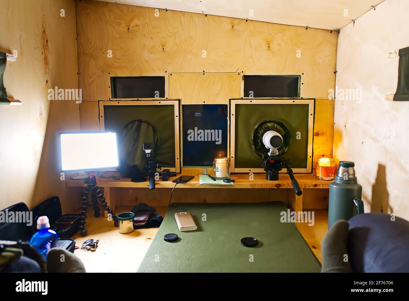 Handmade bird watching cabin inside with photography equipment. Self ...