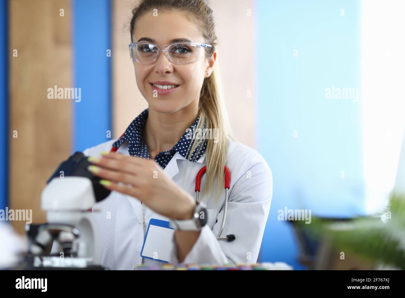 Portrait of smiling research scientist with microscope Stock Photo - Alamy