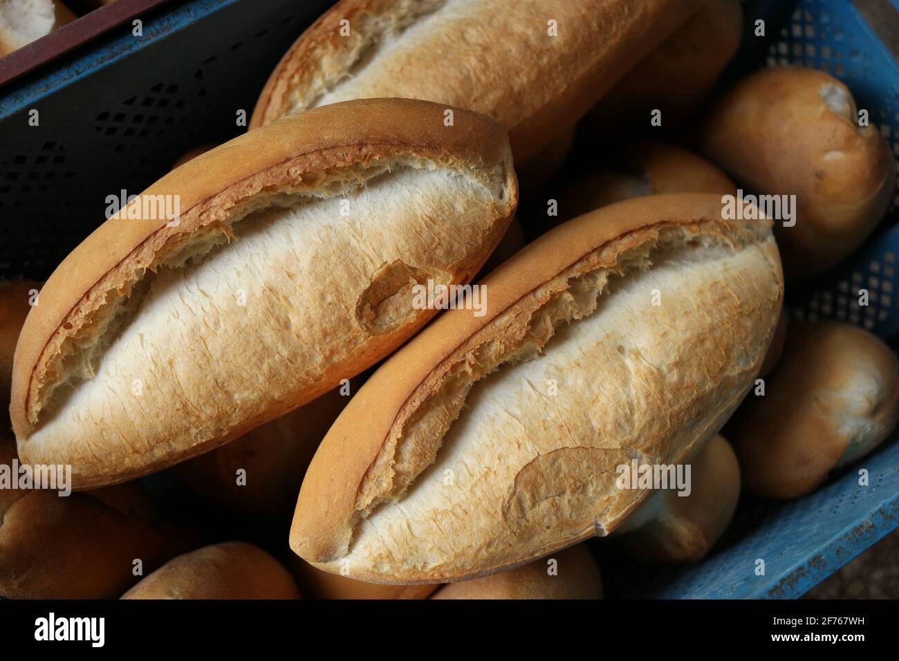 Plastic box full of freshly baked bread Stock Photo - Alamy
