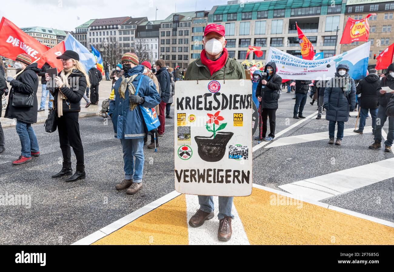 Hamburg, Germany. 05th Apr, 2021. An Easter march participant holds a ...