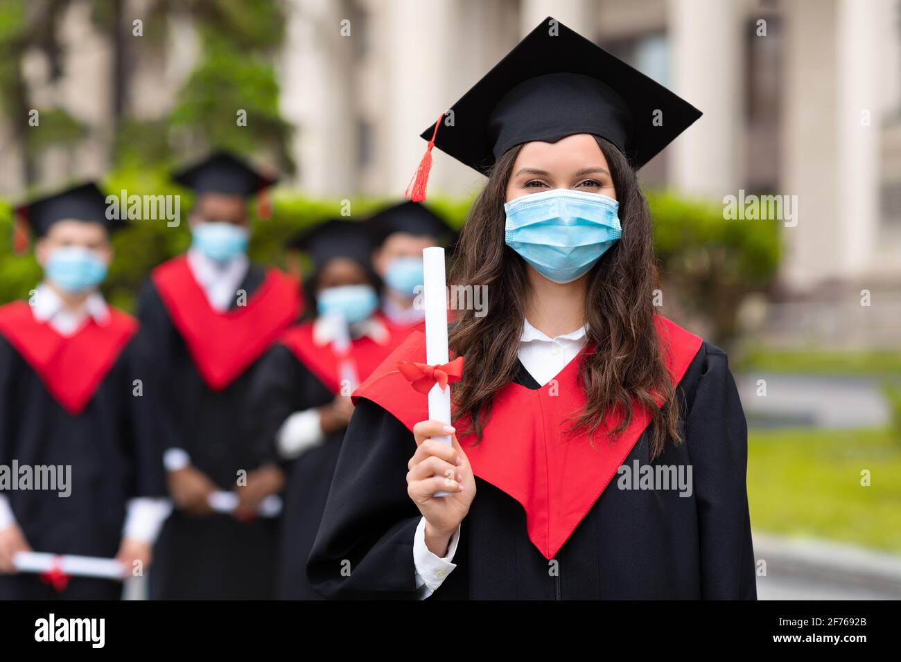 Young lady student in graduation costume showing her diploma Stock ...