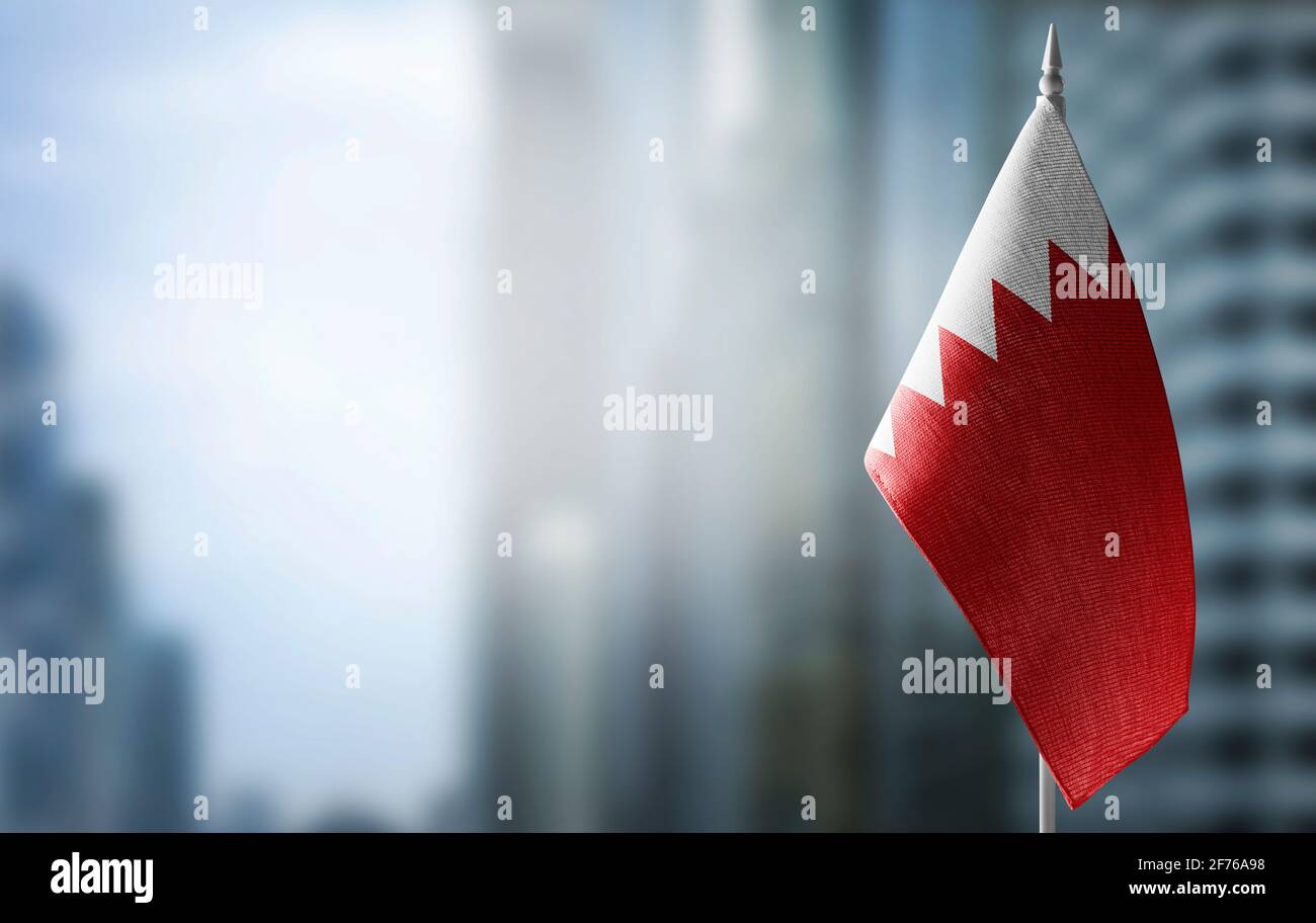 A small flag of Bahrain on the background of a blurred background Stock ...