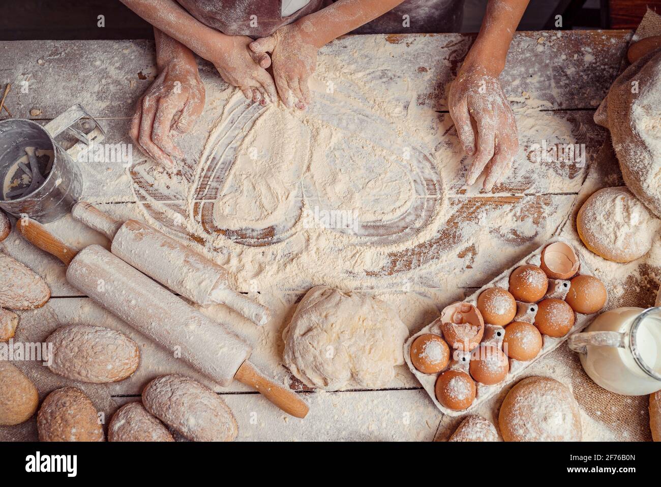 Baking background with heart shape made of flour and food ingred Stock ...