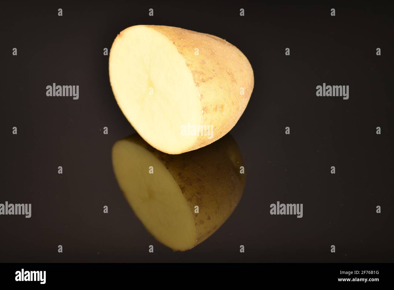 One half fresh, not peeled, raw, organic, juicy potato, macro, on a ...