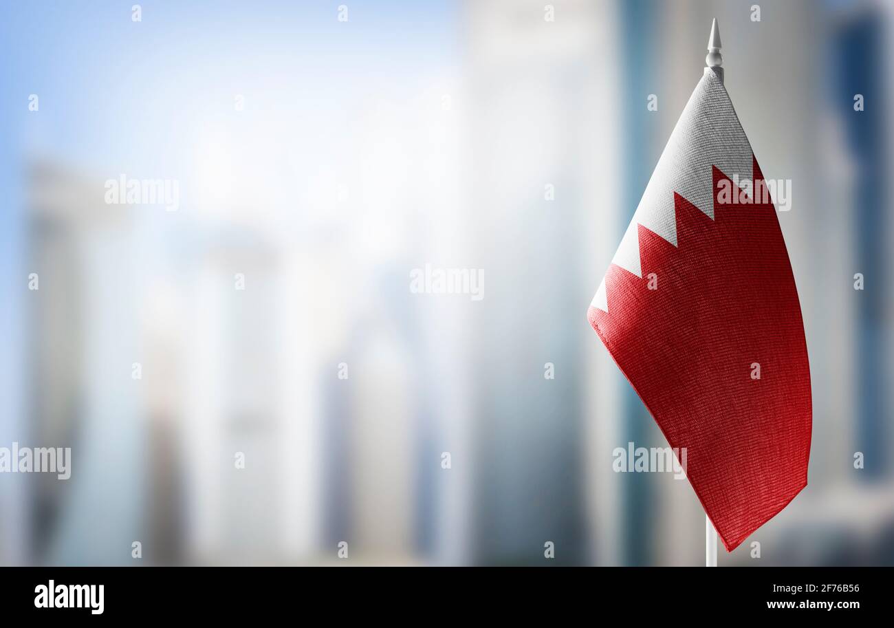 A small flag of Bahrain on the background of a blurred background Stock ...