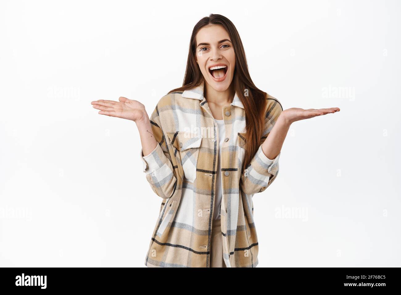 Nothing here. Laughing smiling woman shrugging, showing empty hands and ...