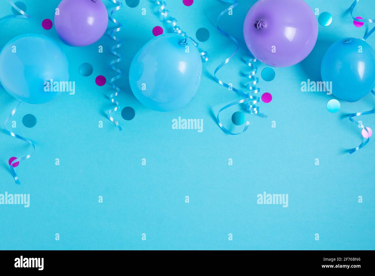 Party background with balloons, streamers and confetti on pastel blue ...