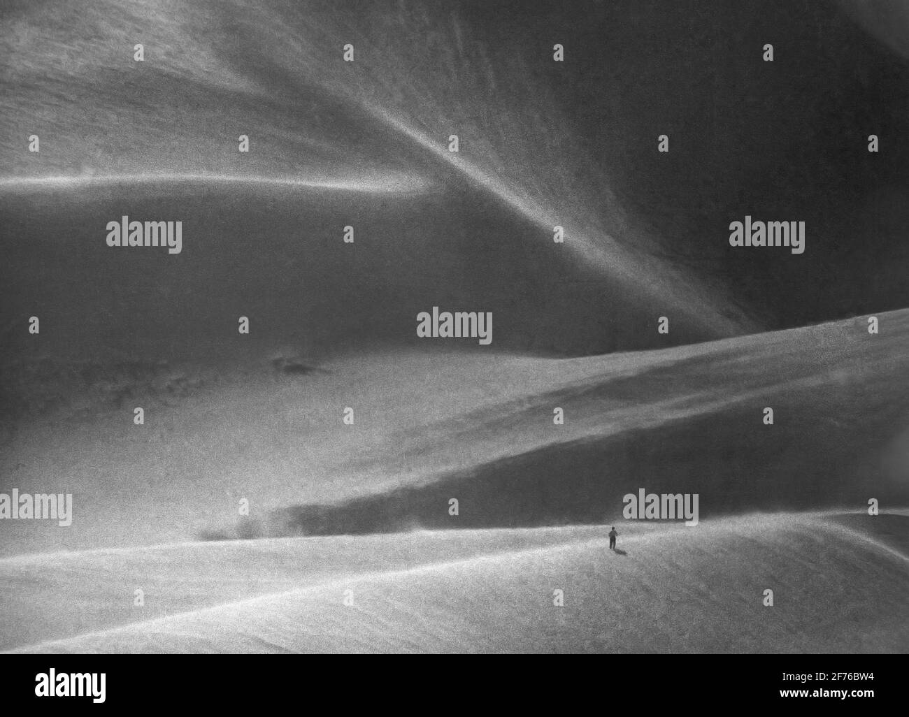 Tiny figure of a man exploring the Great Sand Dunes National Park and ...