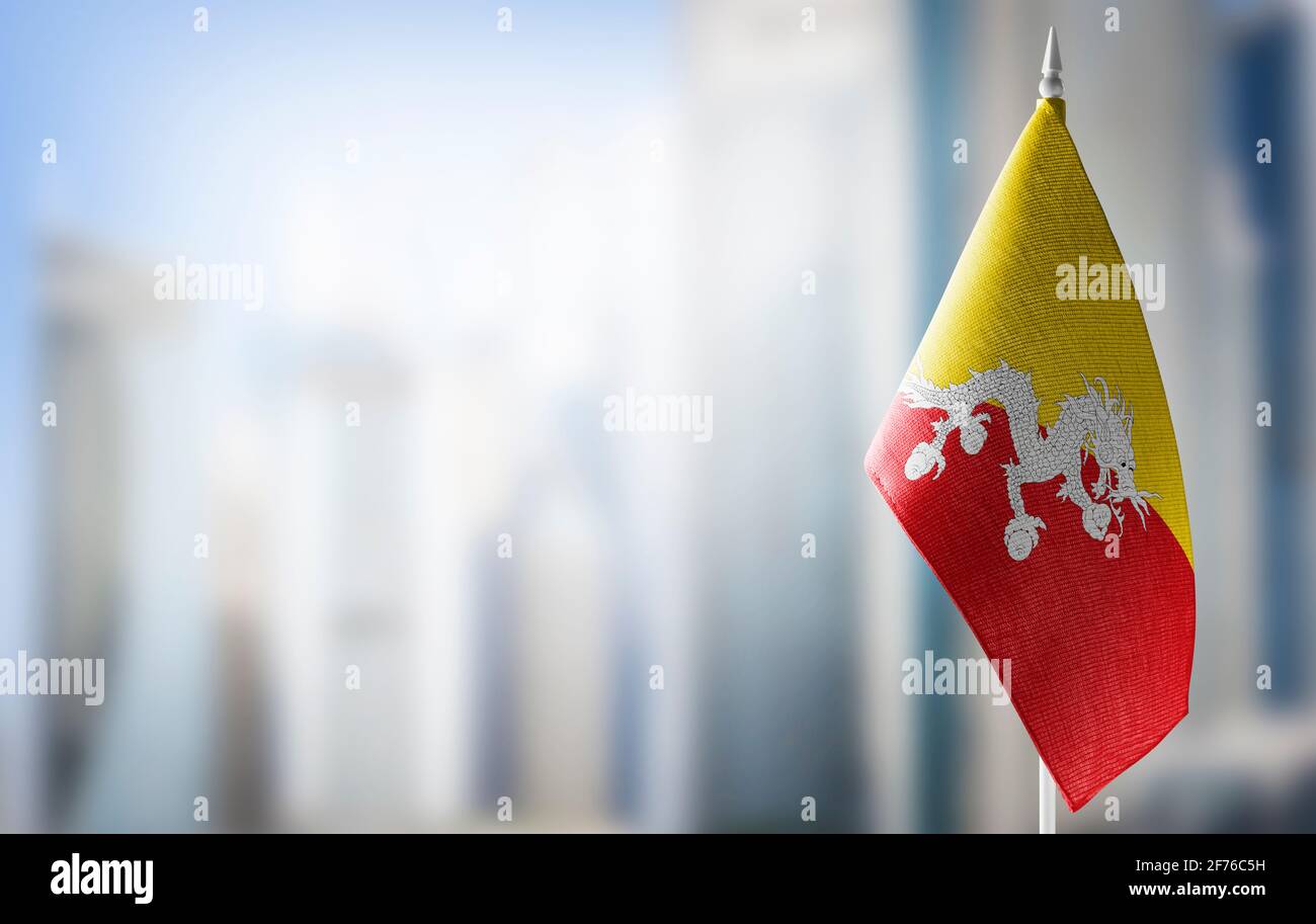 A small flag of Bhutan on the background of a blurred background Stock ...