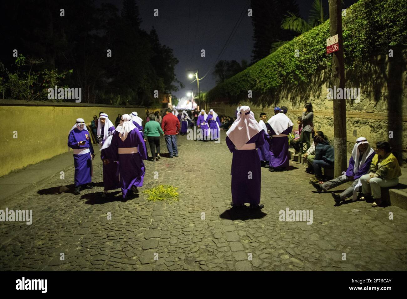 Cucuruchos in purple robes process solemnly through the streets of ...