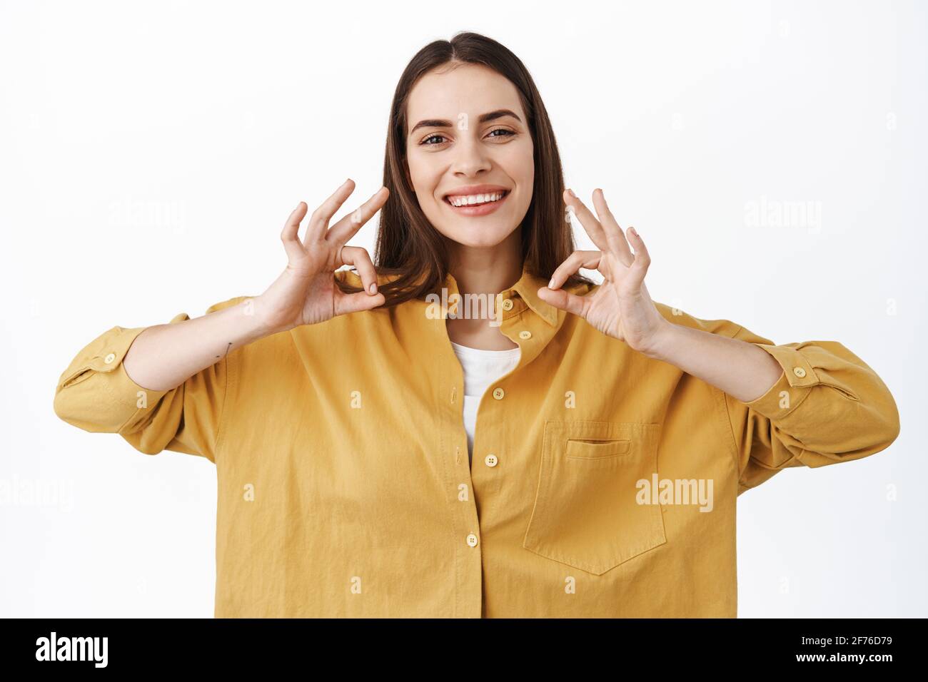 Very well, yes. Smiling caucasian woman shows okay signs, make OK ...
