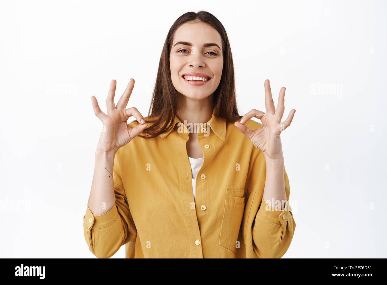 Very good. Smiling attractive woman shows okay approval gesture, like ...