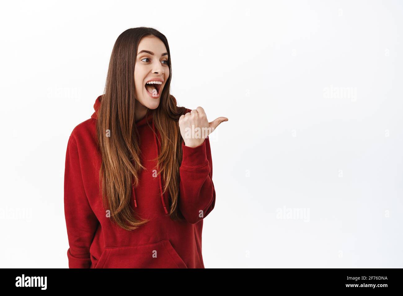 That way, look. Cheerful female model with long natural hair pointing ...