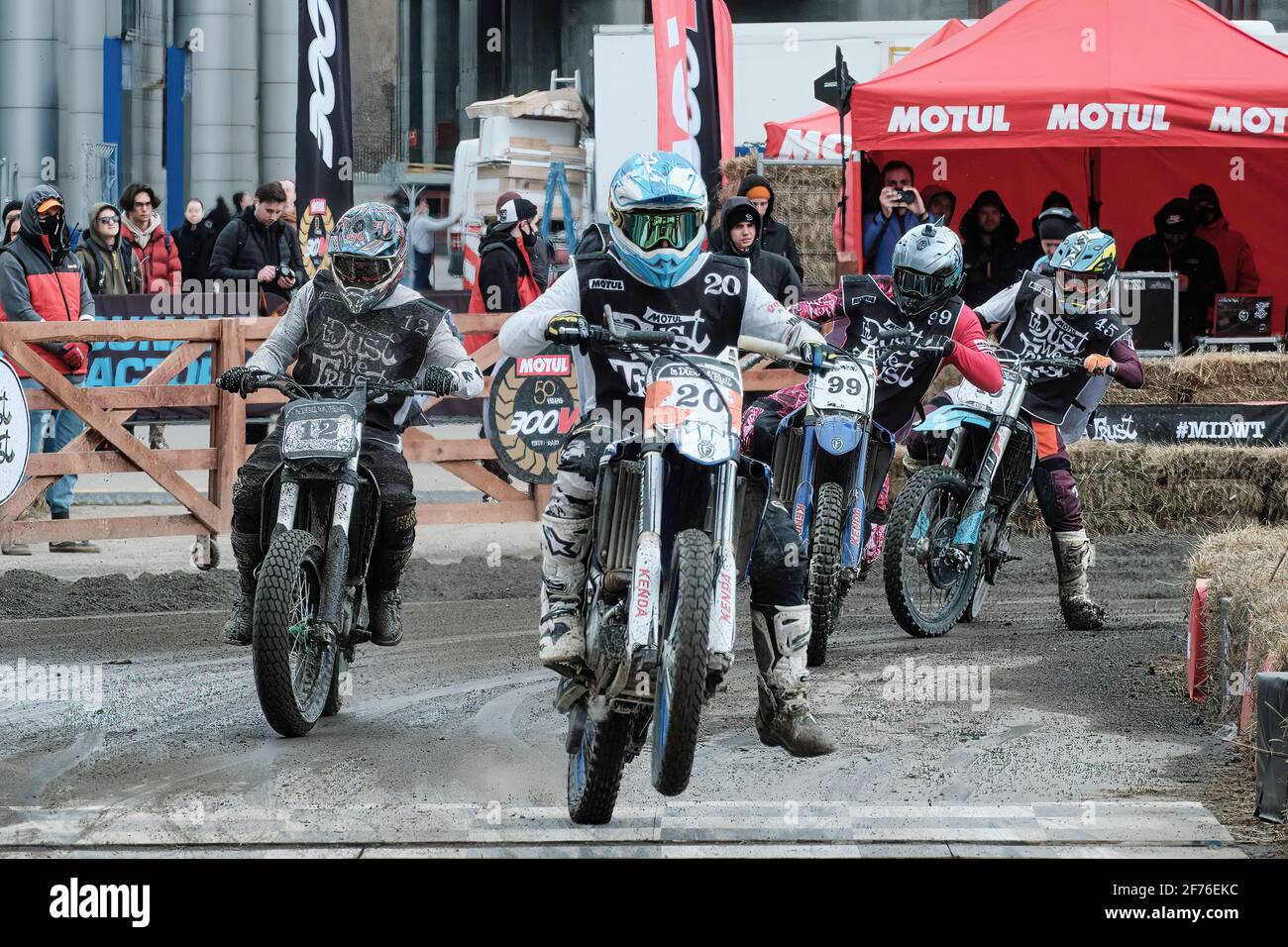 The leader of the race rides on the rear wheel during the exhibition ...