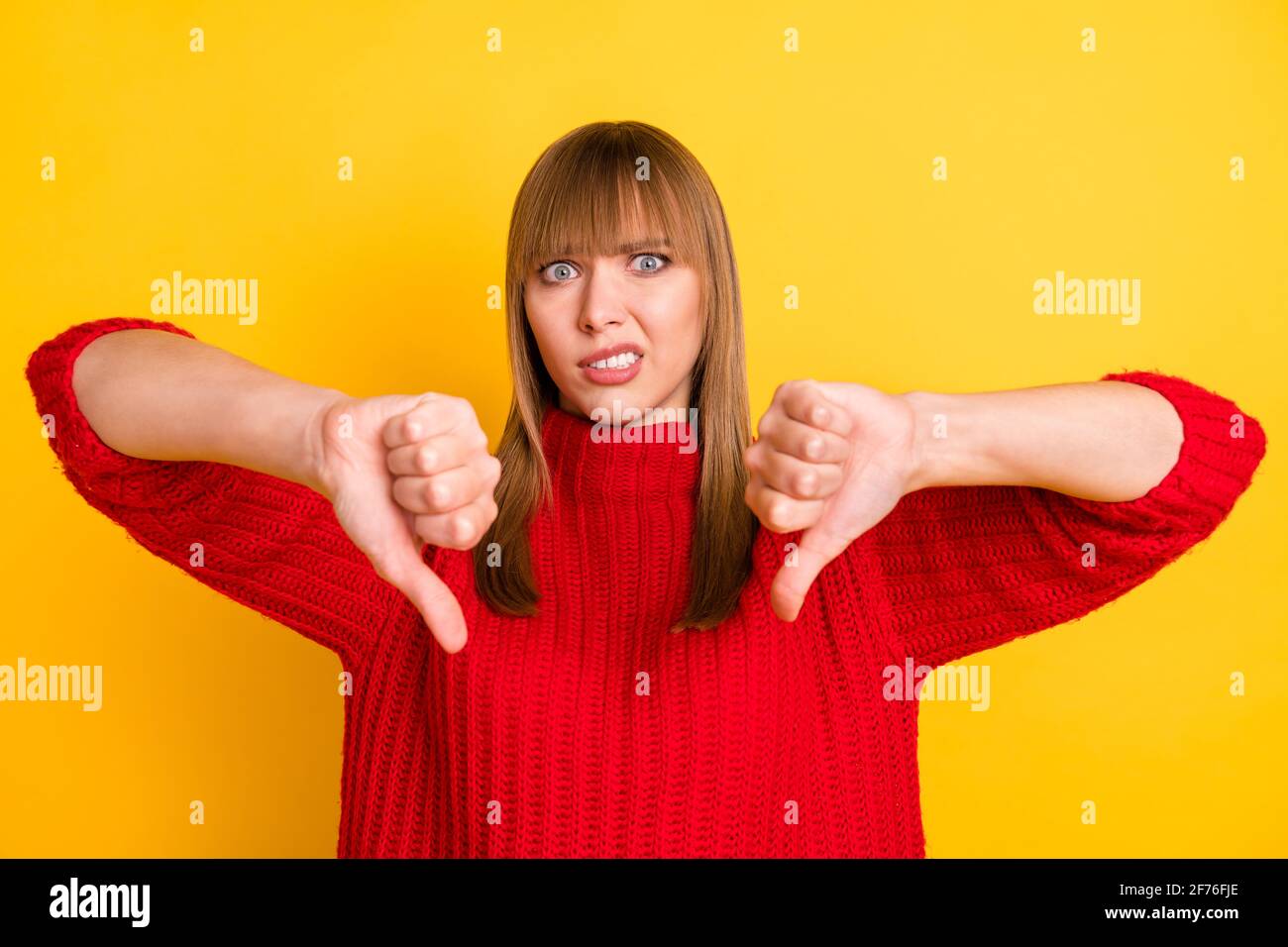 Photo of blond sad lady show thumb down wear red sweater isolated on ...